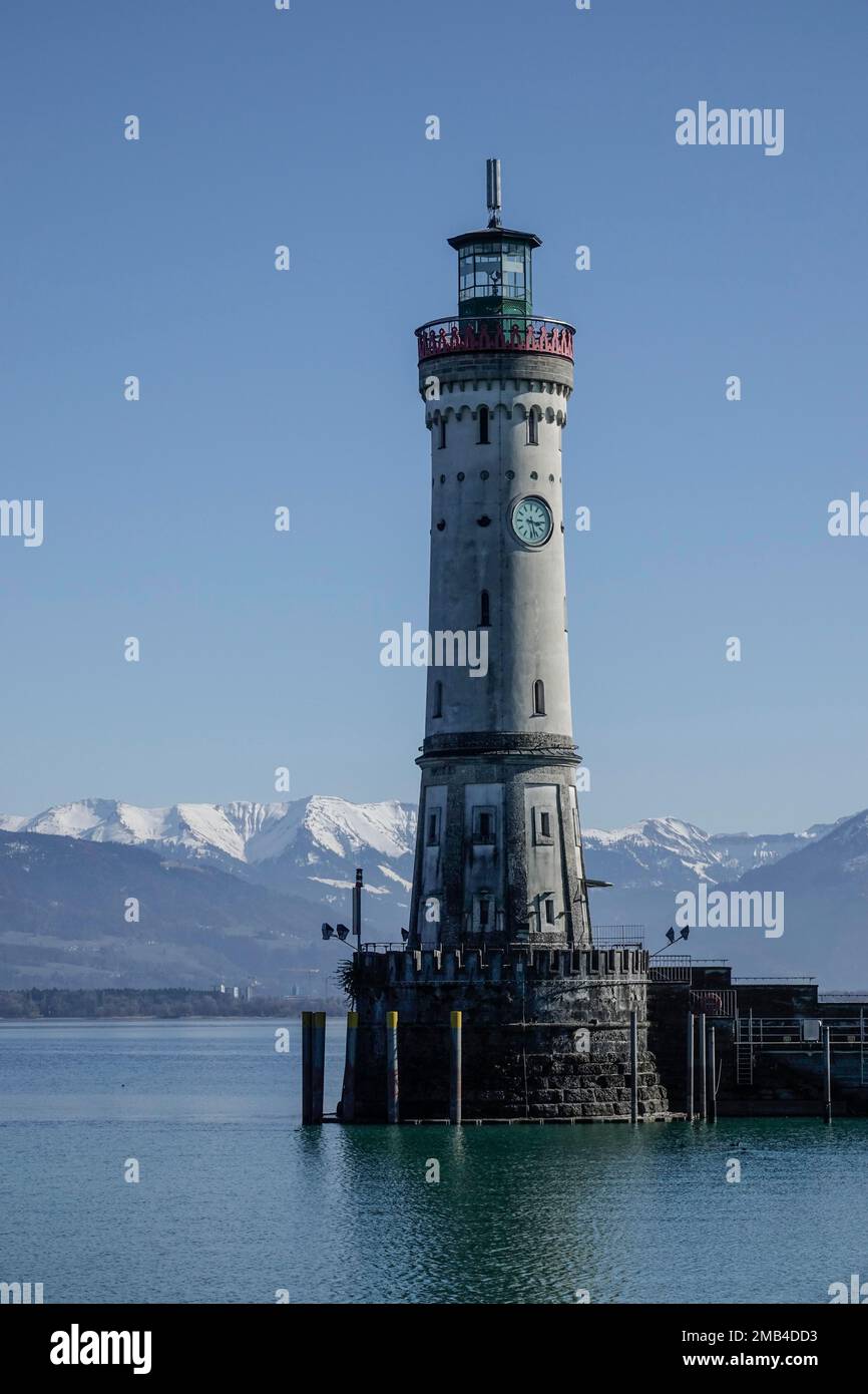 New lighthouse at the harbour entrance, snow-covered mountains in the ...