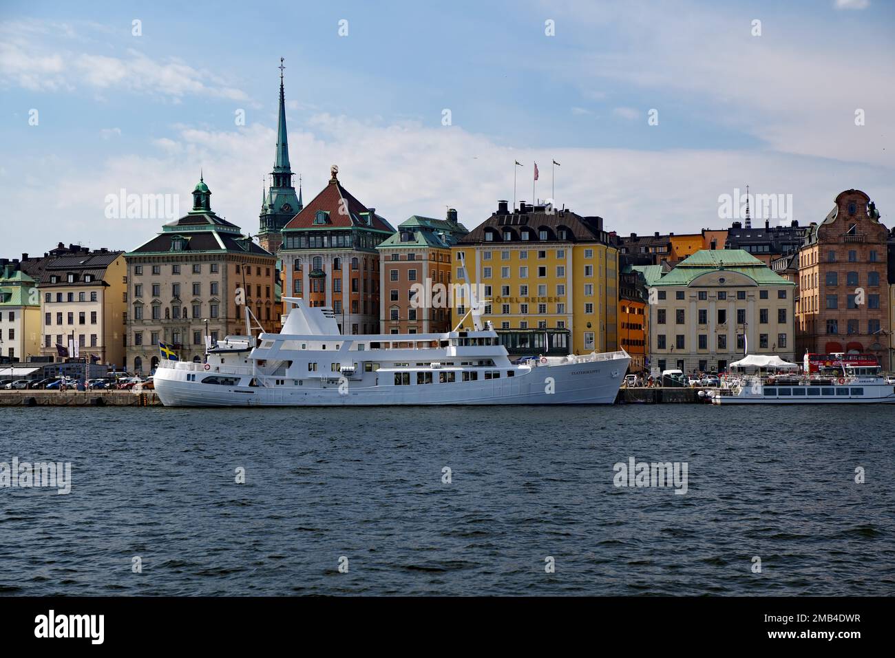Excursion boats in front of old town houses in Gamla Stan district ...
