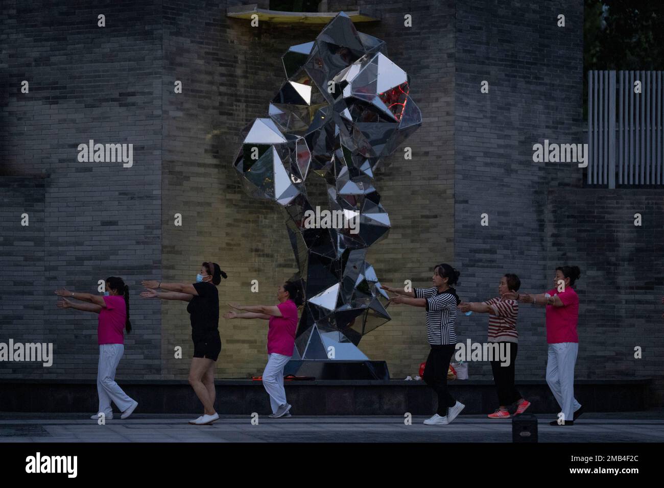 Chinese women take part in plaza dancing, Friday, July 8, 2022, in ...