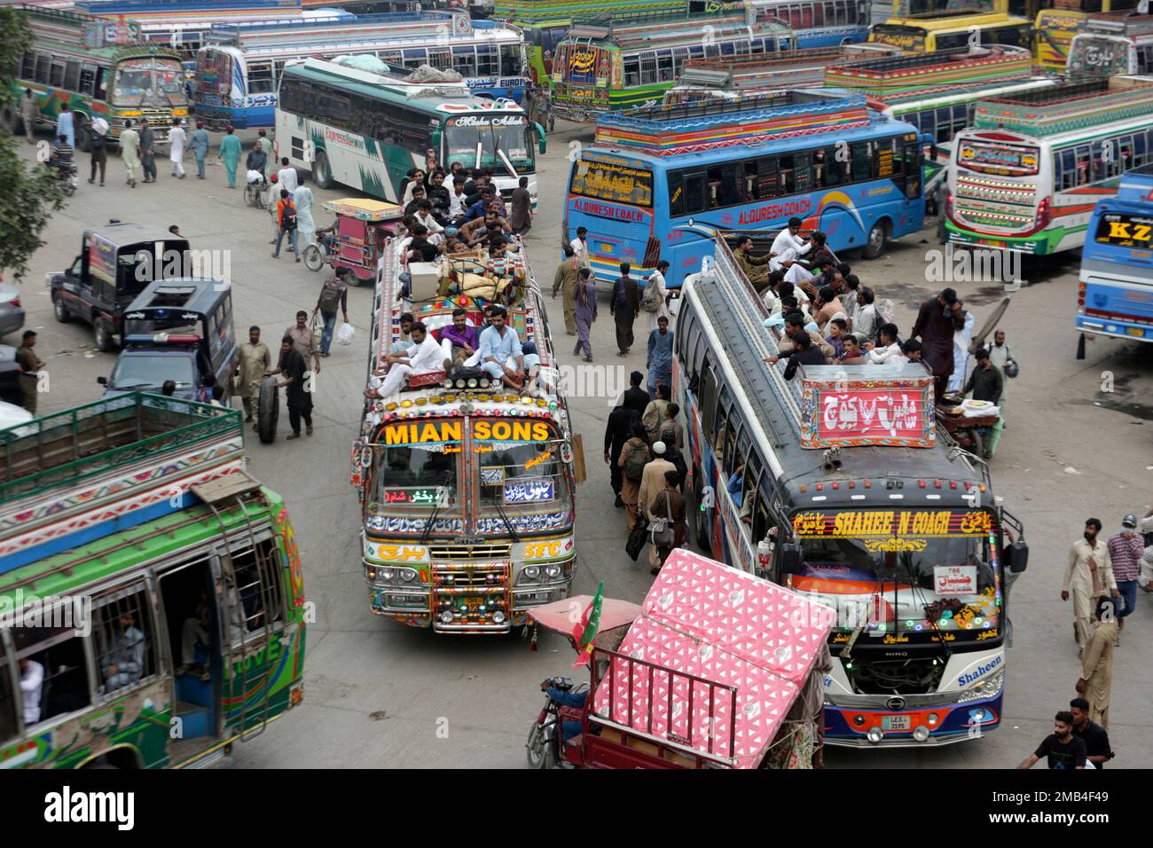 Pakistanis ride a crowded buses as people travel to their hometowns and ...