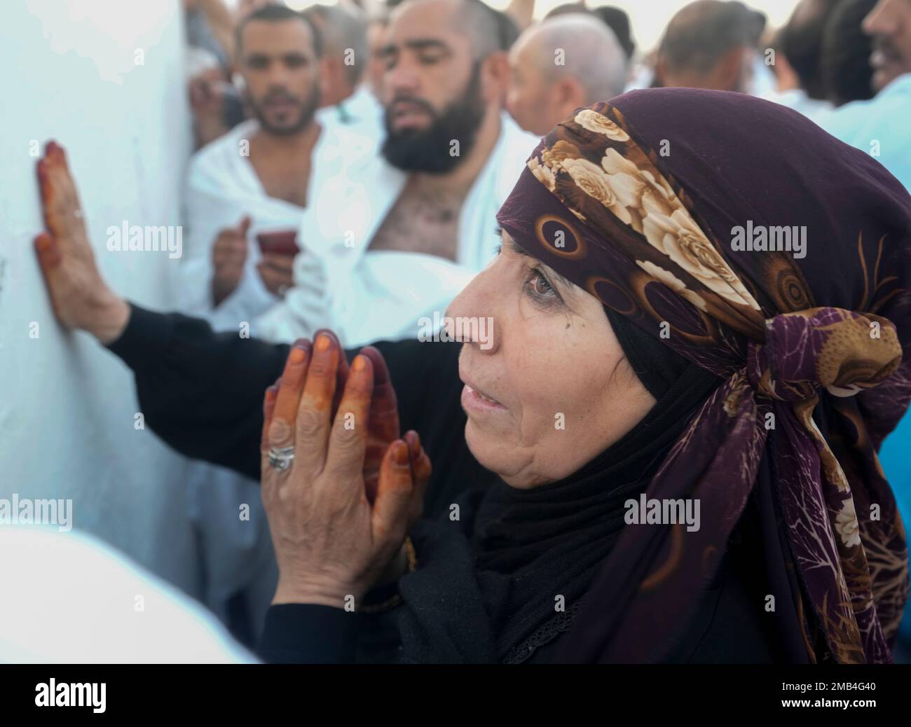 A Muslim pilgrim prays on the rocky hill known as the Mountain of Mercy ...