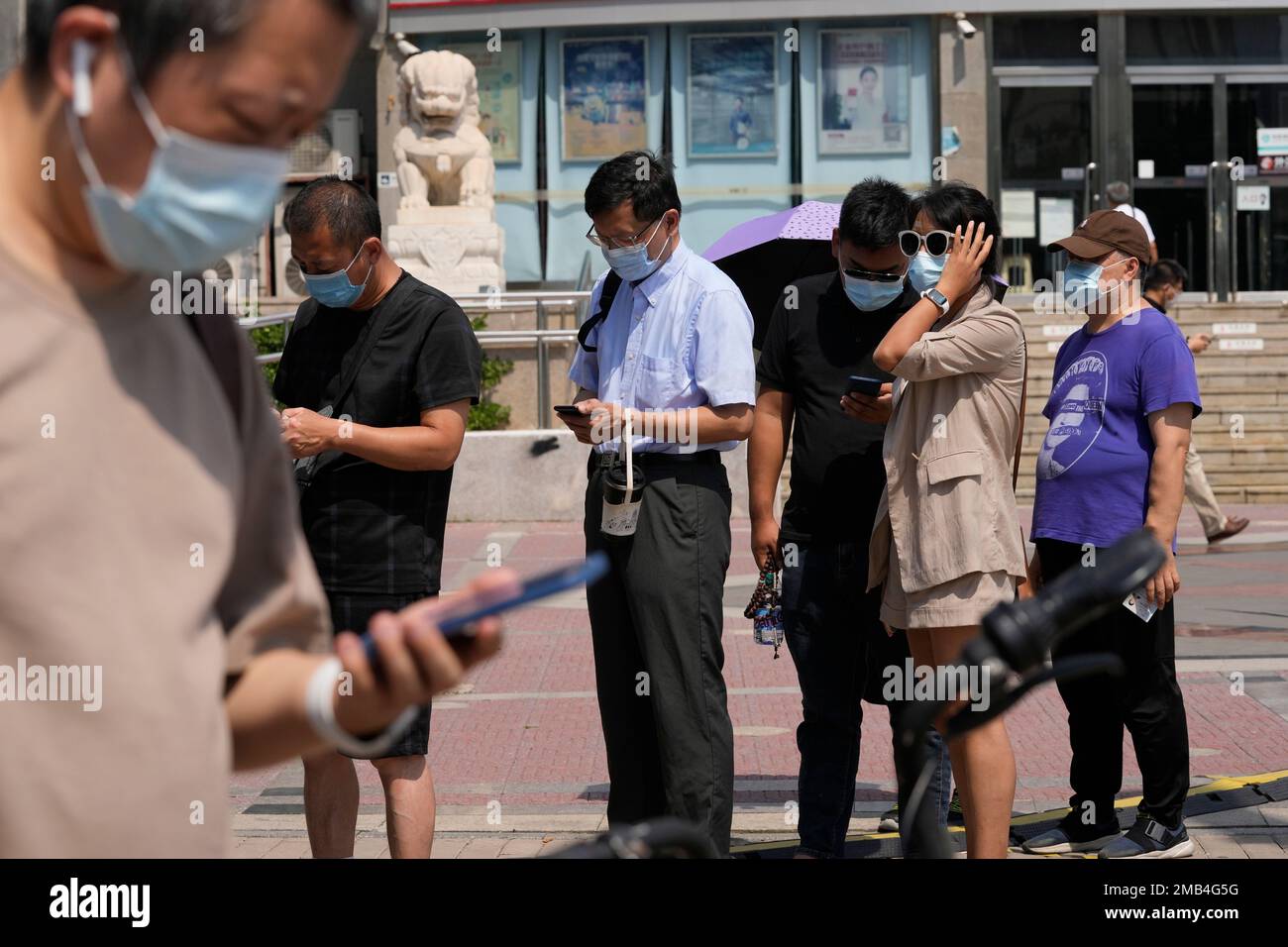 Residents wearing masks wait in line for COVID-19 testing, Friday, July ...