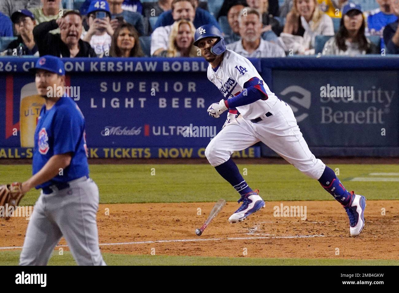 Los Angeles Dodgers' Mookie Betts, right, heads to first as he hits a ...