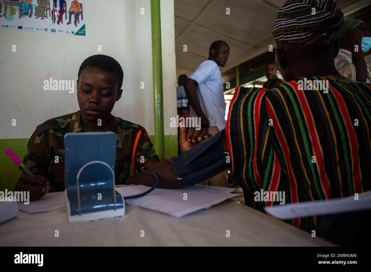 A Ghanaian Army solider takes vitals on a local civilian during a ...