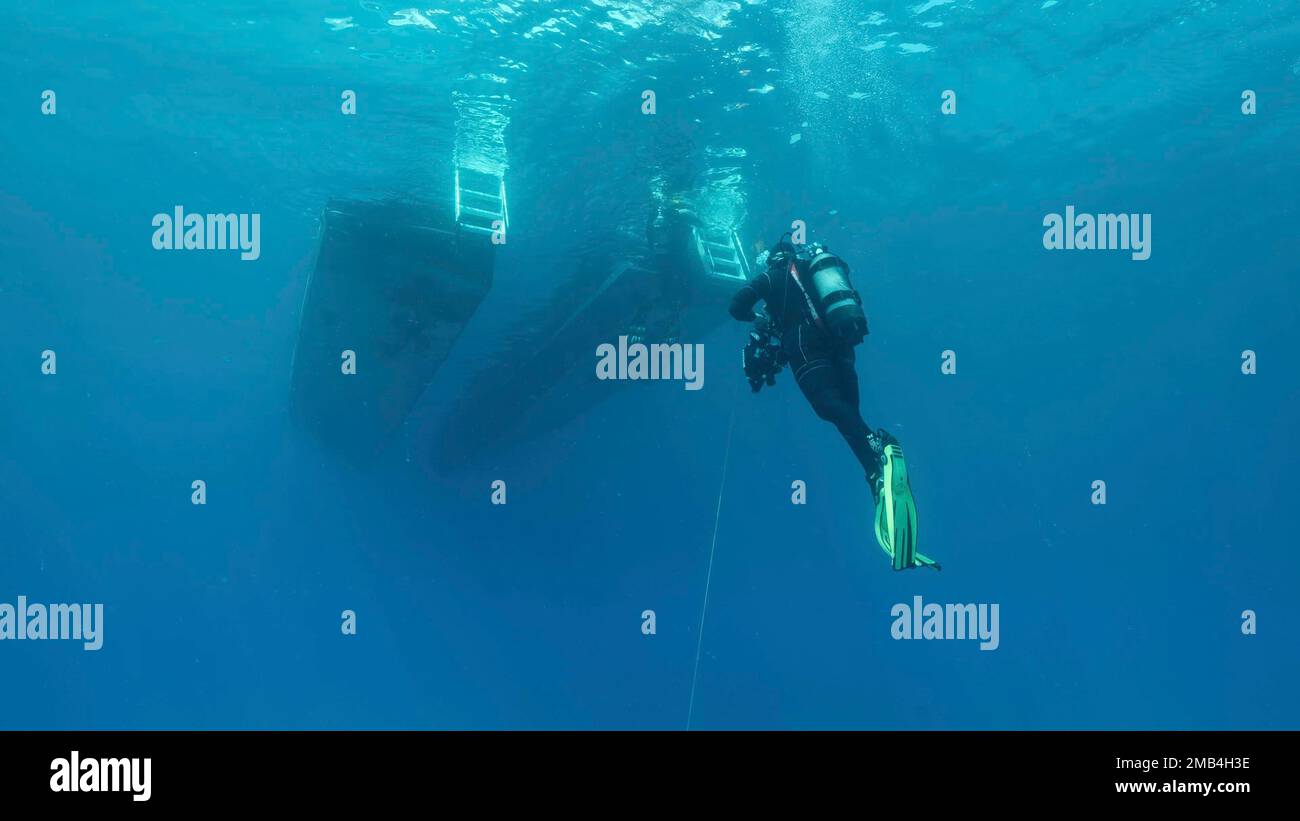 Scuba diver swim towards diving boat in blue water. Mediterranean Sea ...