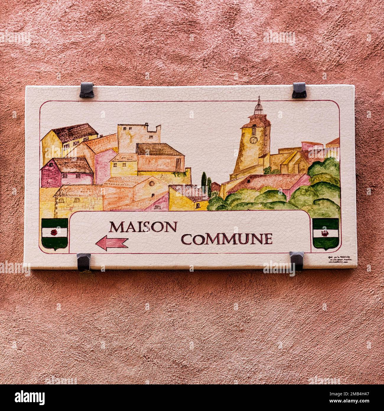 Sign on red wall, signpost to the town hall with view of the old town ...