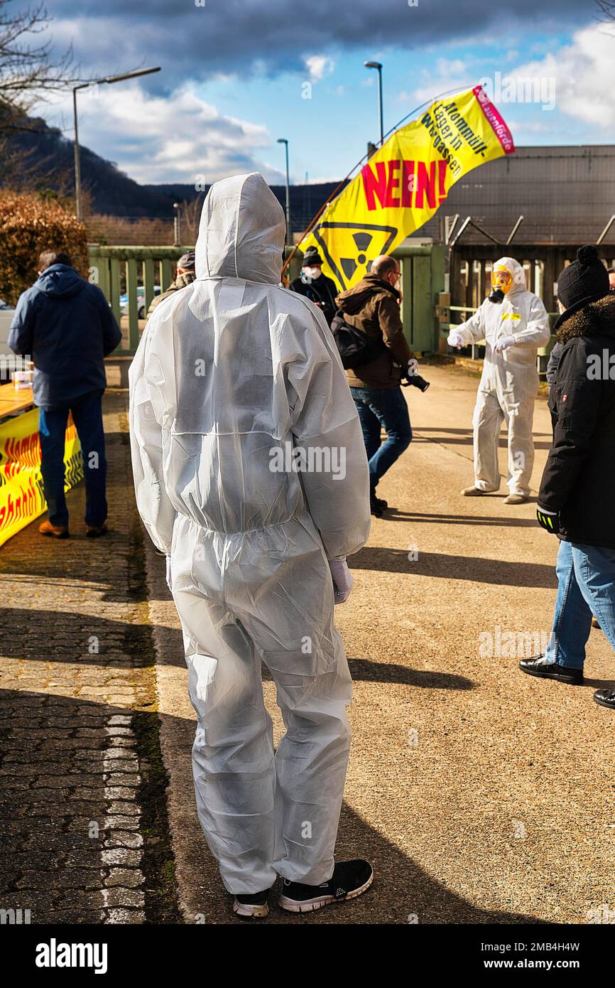 People in protective suits and with gas masks demonstrate against the ...