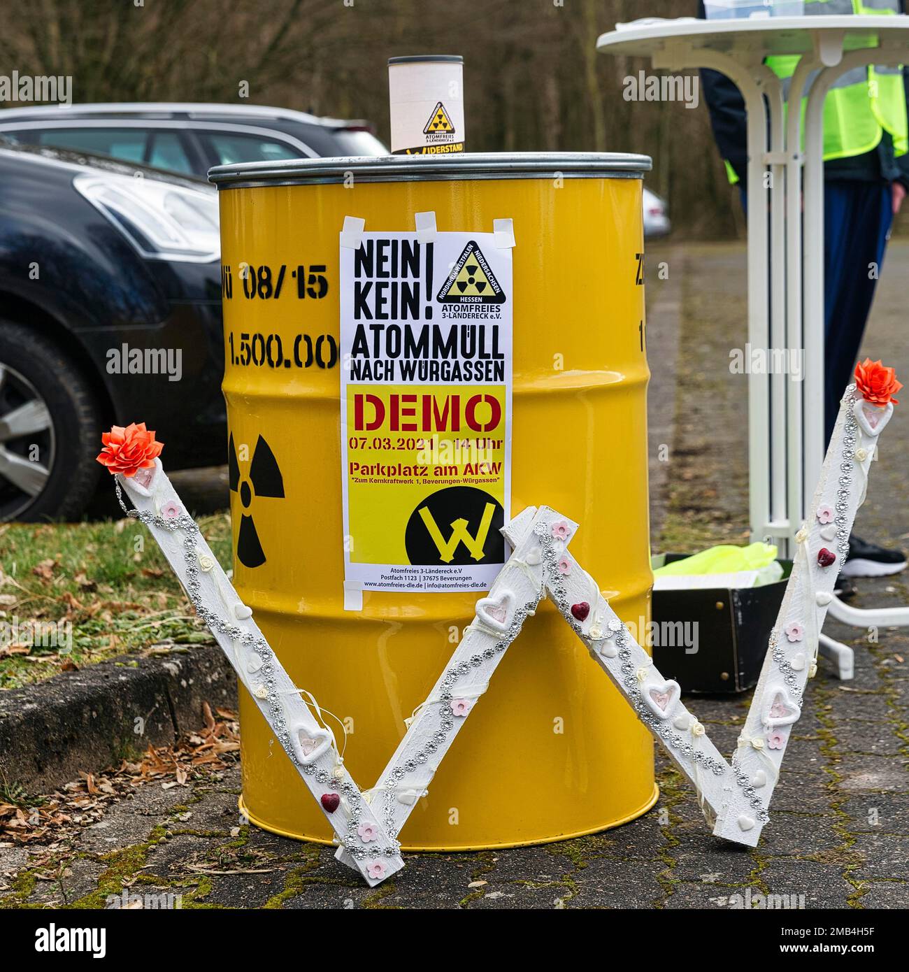 Yellow metal barrel with sign for radioactivity and poster, nuclear ...