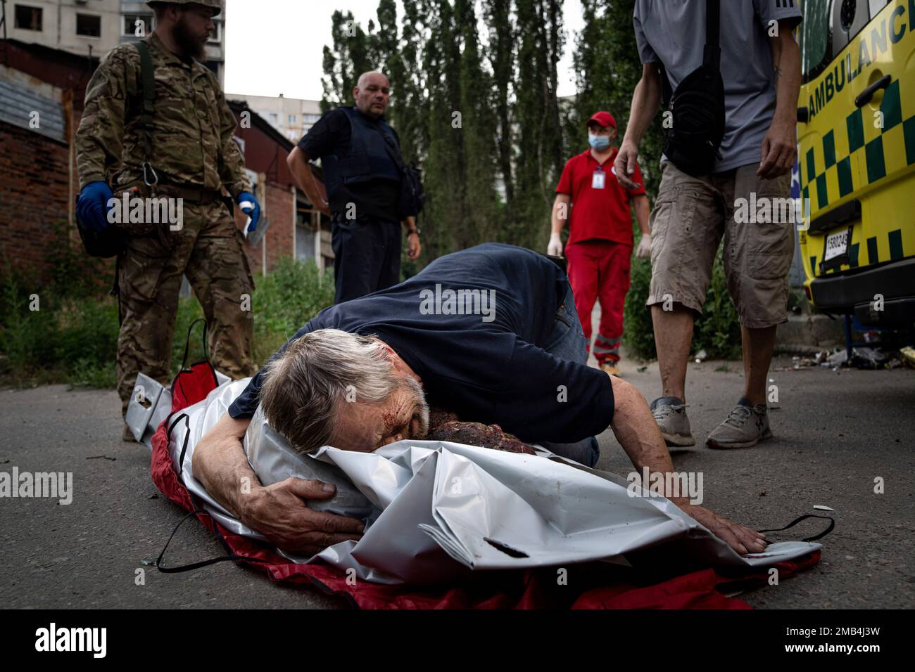 Viktor Kolesnik cries on a body of his wife Natalia Kolesnik, who was ...