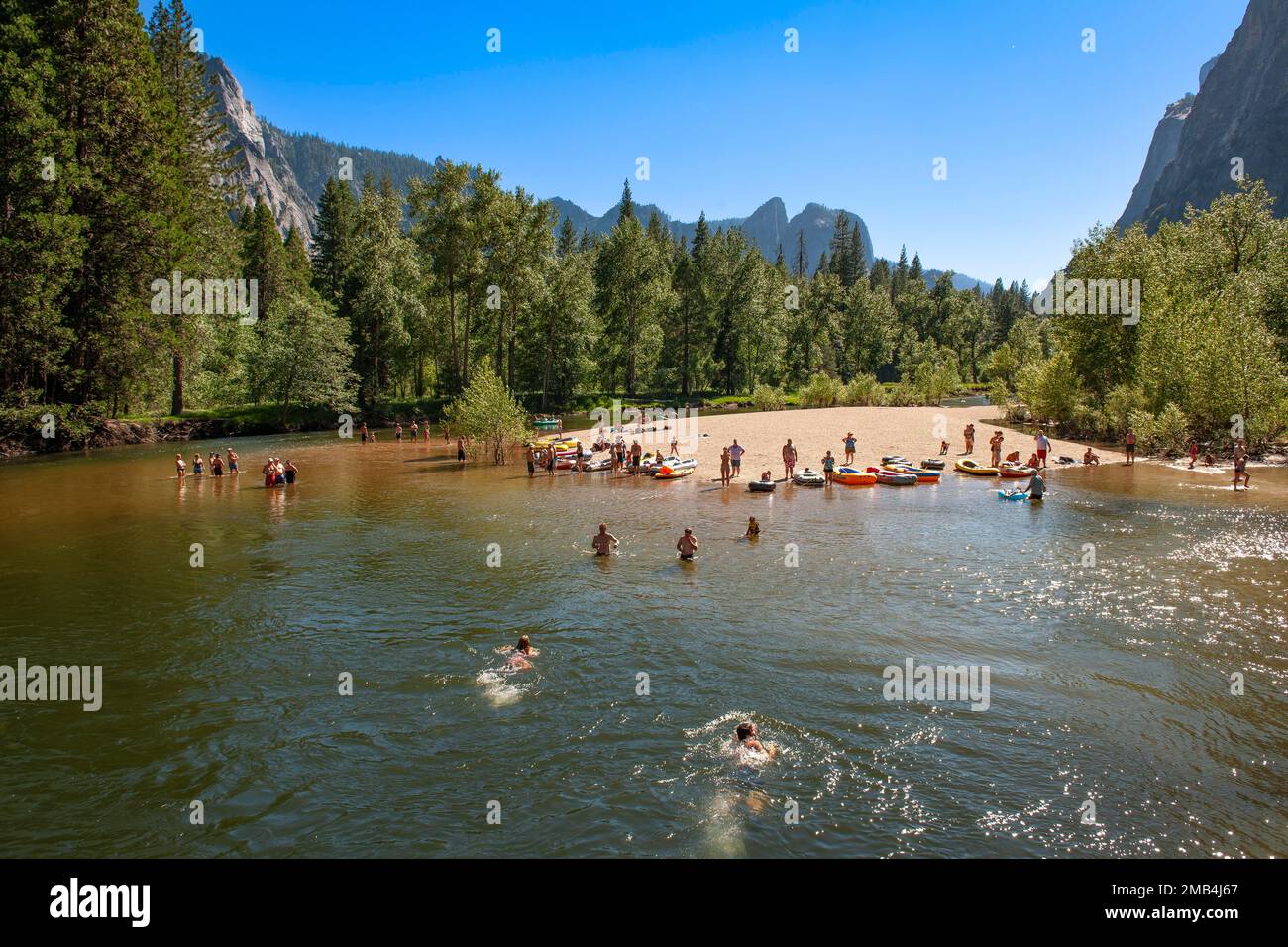 Tourists bathing in the Merced River in Yosemite National Park ...