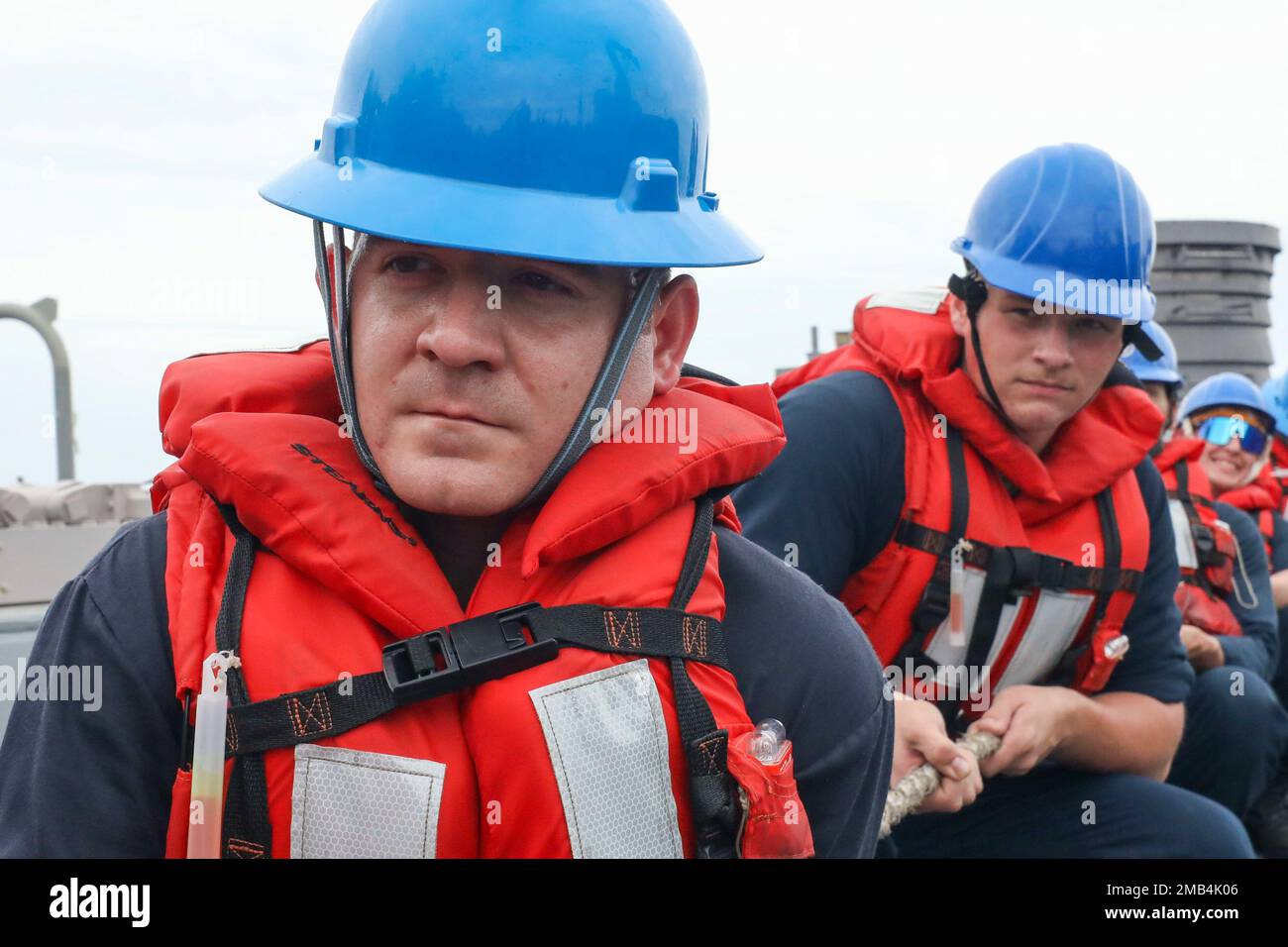 PHILIPPINE SEA (June 11, 2022) Sailors hold a line aboard Arleigh Burke ...