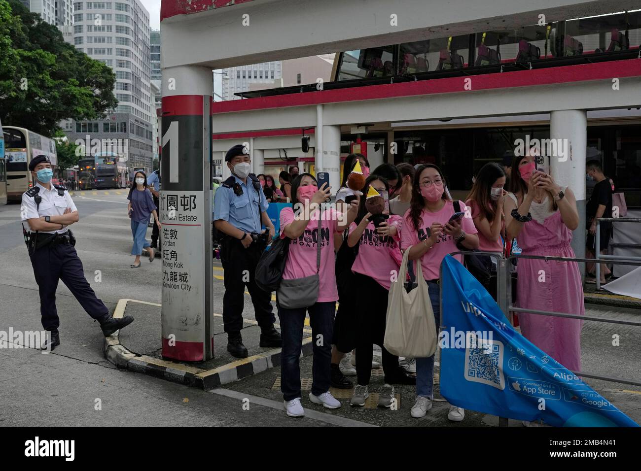Police officers stand guard as fans of Anson Lo, Hong Kong singer and a ...