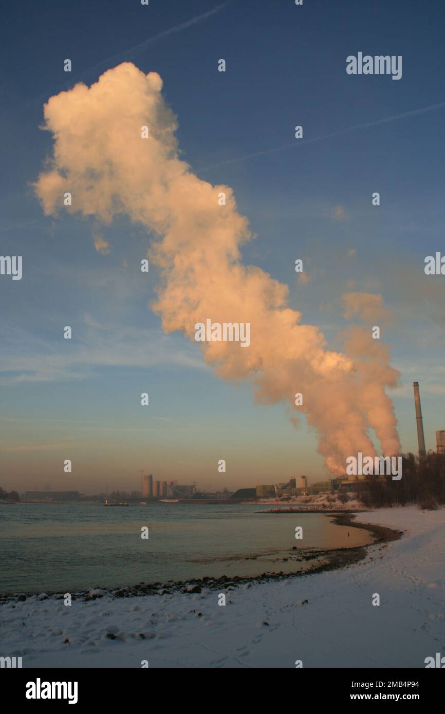 a smoky coke factory on the snowy beaches of the river rhine Stock ...
