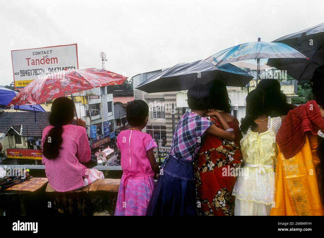 Girls with umbrella admiring Atham festival procession in Tripunithura ...