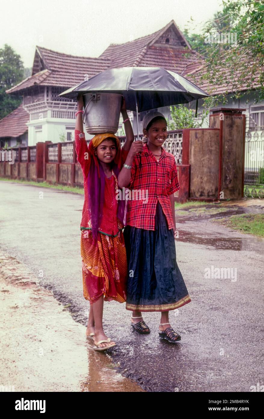 Two girl children with umbrella on a rainy day in Kottayam, Kerala ...
