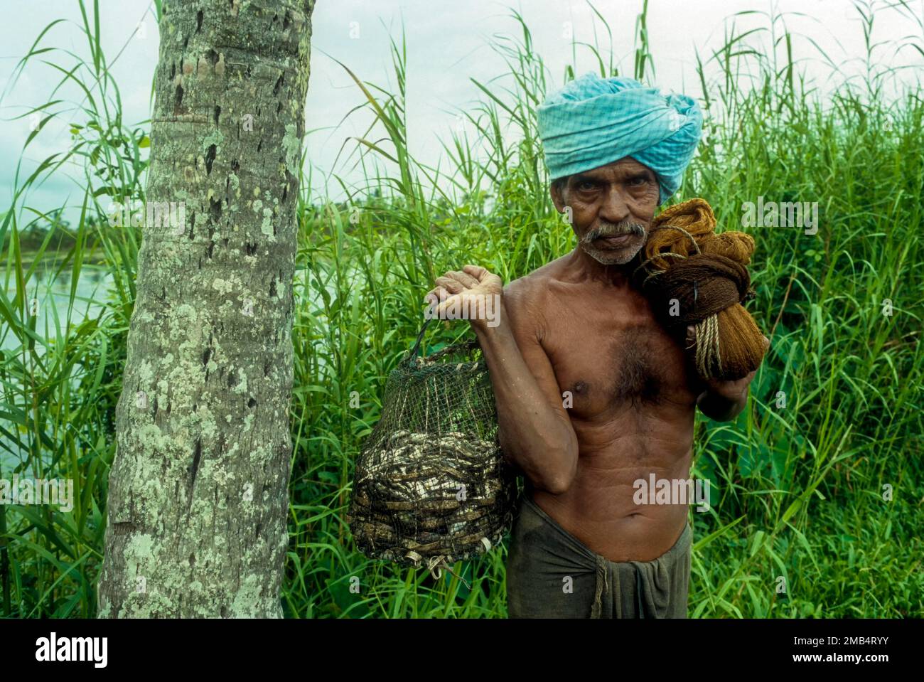 Fisherman with his catch in Kodungallur, Kerala, India, Asia. Old man ...