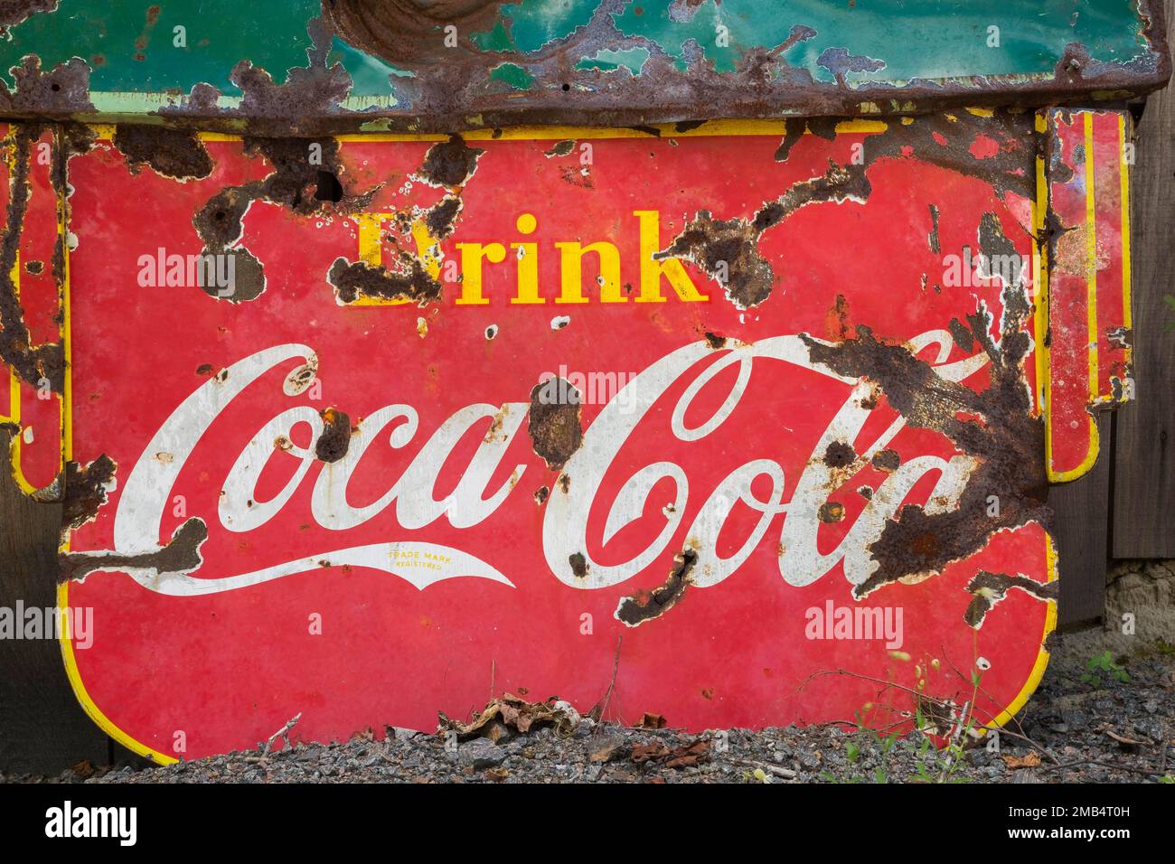 Vintage Drink Coca Cola advertising sign in front of wood plank storage ...