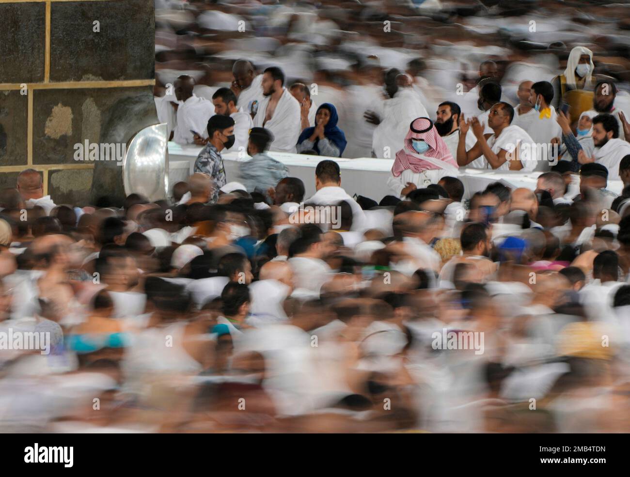 In this photo taken with low shutter speed, Muslim pilgrims pray as ...