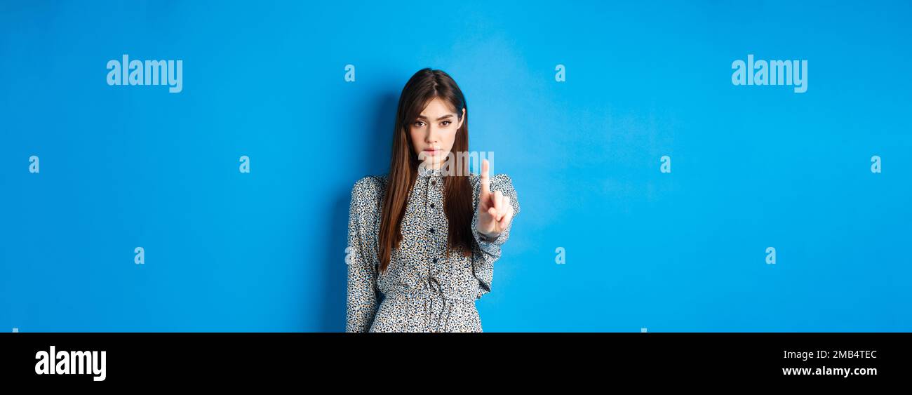 Serious woman looking confident and shaking finger, say no, stop you ...