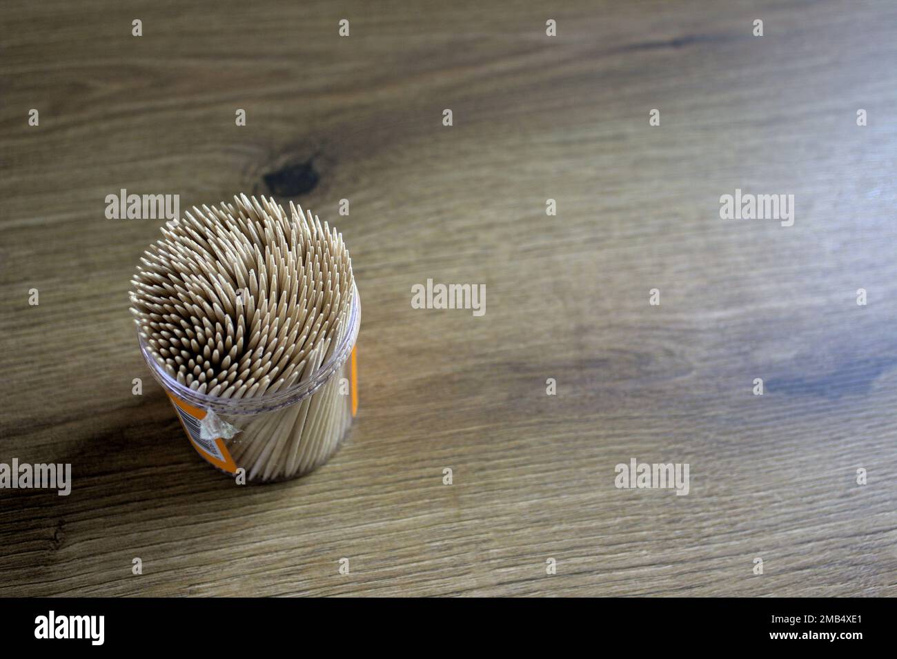 Brown toothpicks in their holder lying on a wooden kitchen table in ...