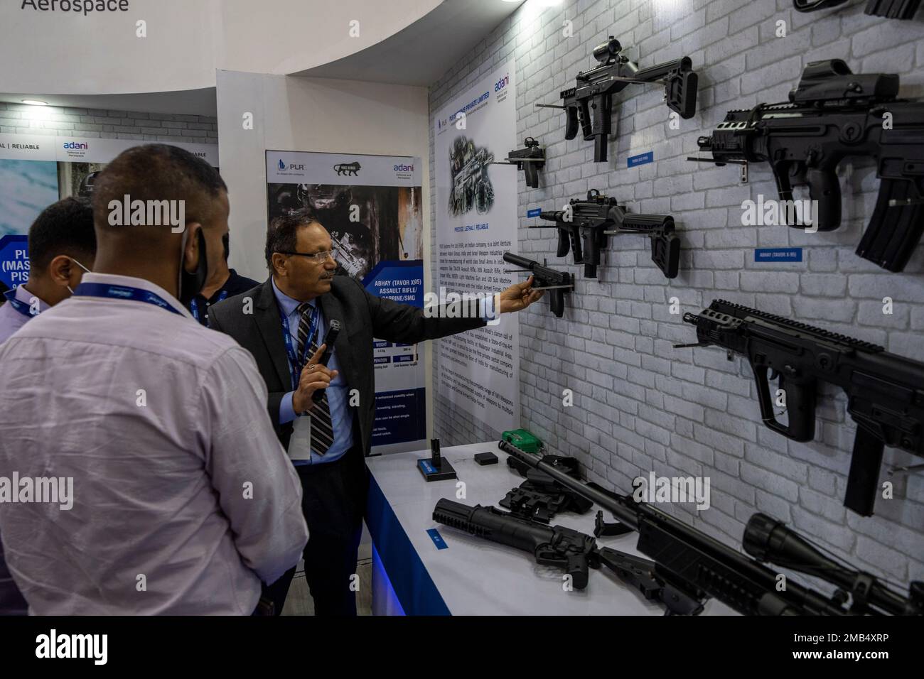 An exhibitor shows the working of a pistol manufactured by PLR Systems ...