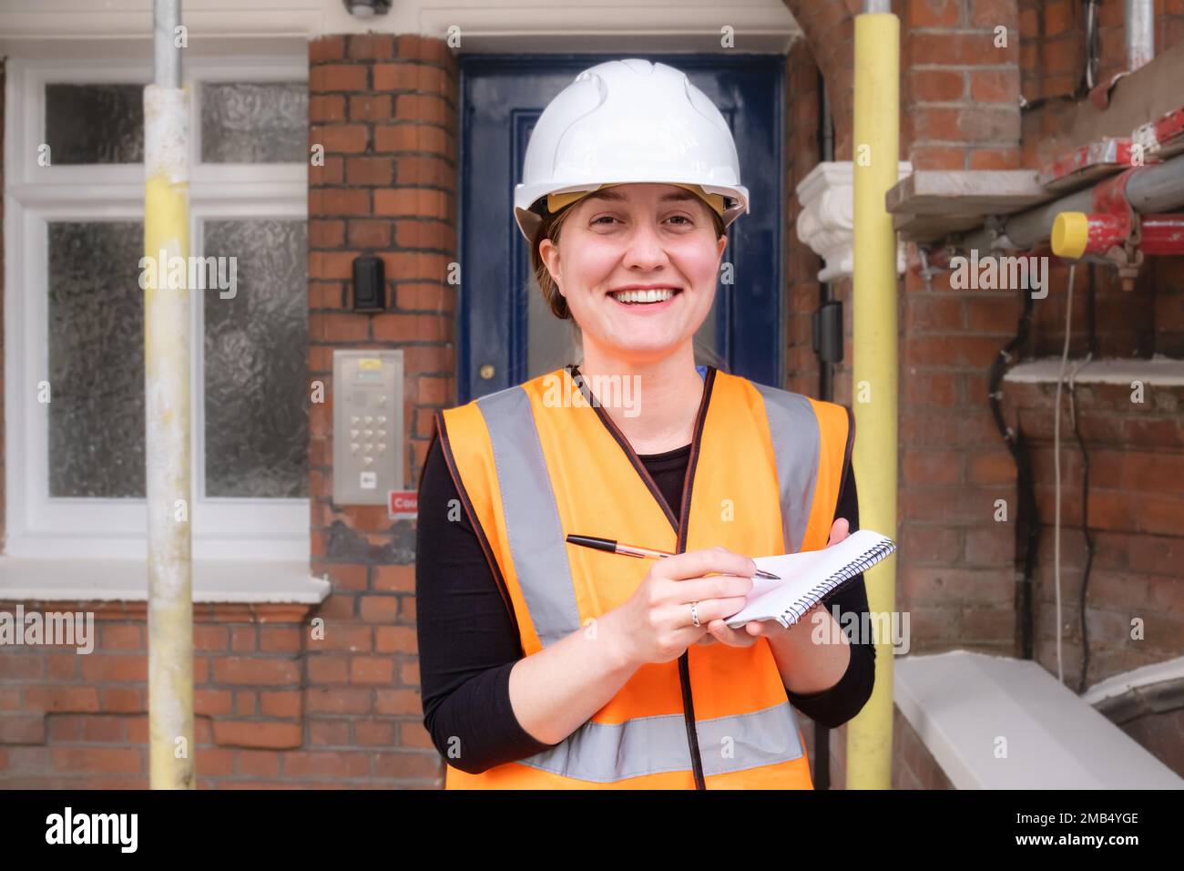 Laughing civil engineer lady inspecting and supervising a construction ...