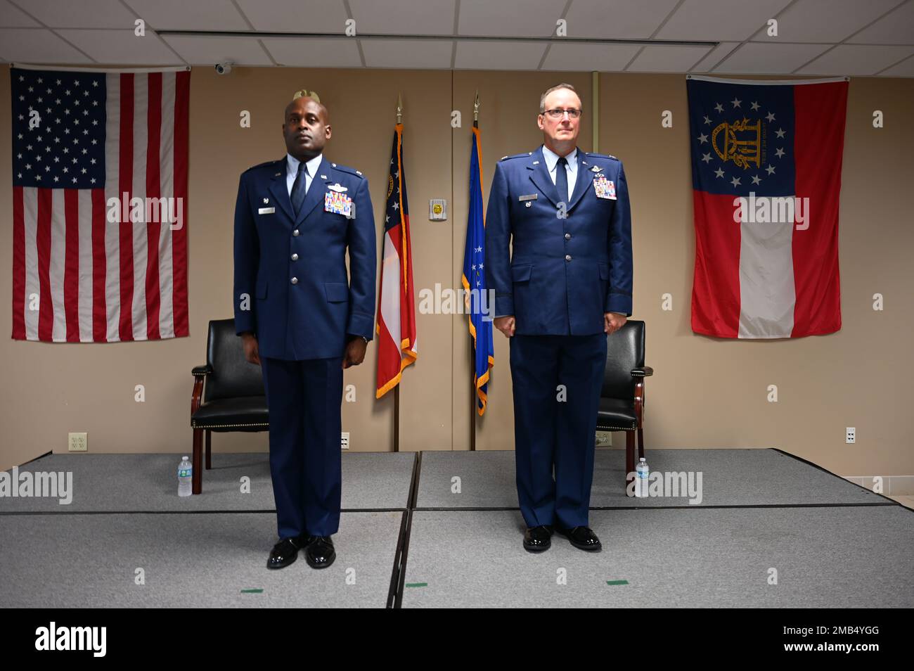 U.S. Air Force Col. Sheldon Wilson presents a retirement certificate to ...
