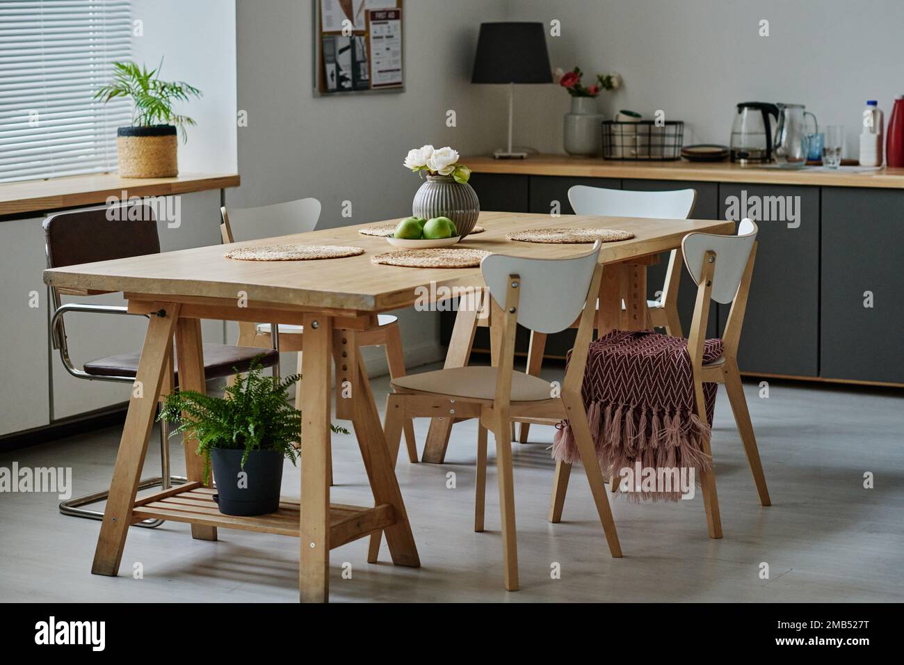 Horizontal image of modern kitchen with wooden dining table in the ...