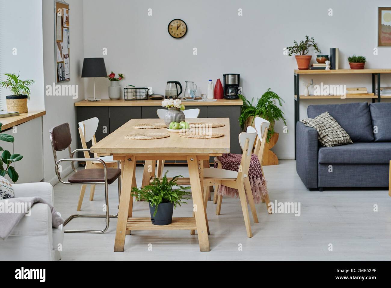 Horizontal image of modern apartment with wooden dining table Stock ...