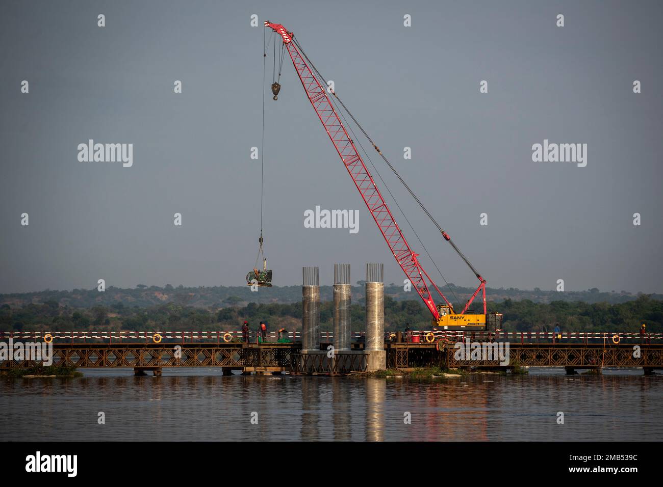 A new bridge over the Nile river in the process of being constructed is ...