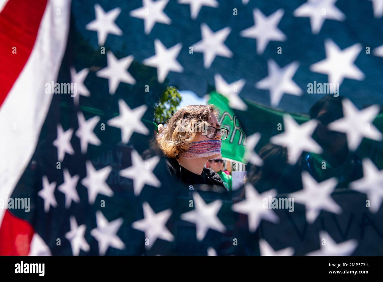 Emma Rousseau of Oakland, N.J., binds her mouth with red white and blue ...
