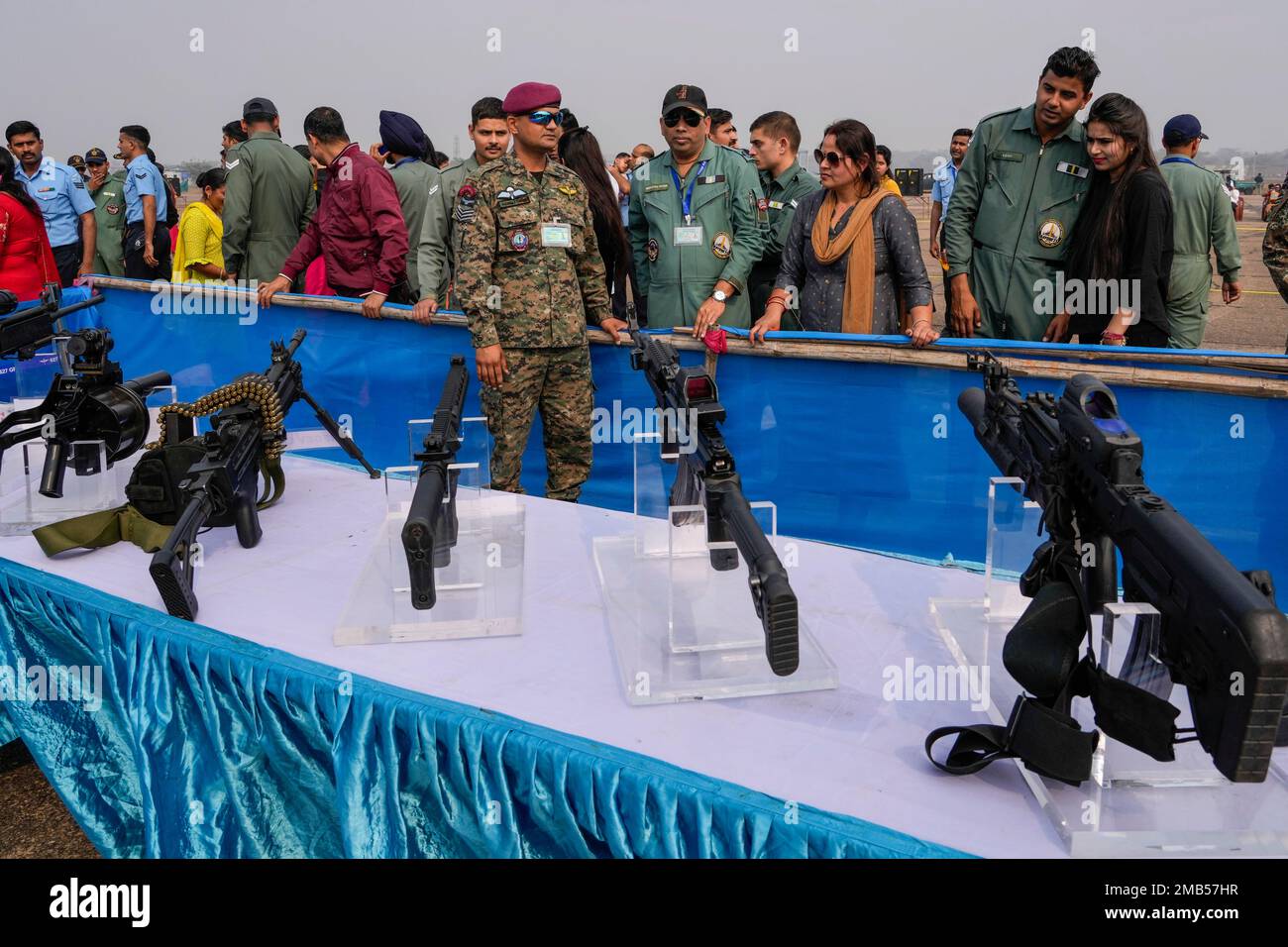 People watch a display of arms and ammunition during an aerobatic ...