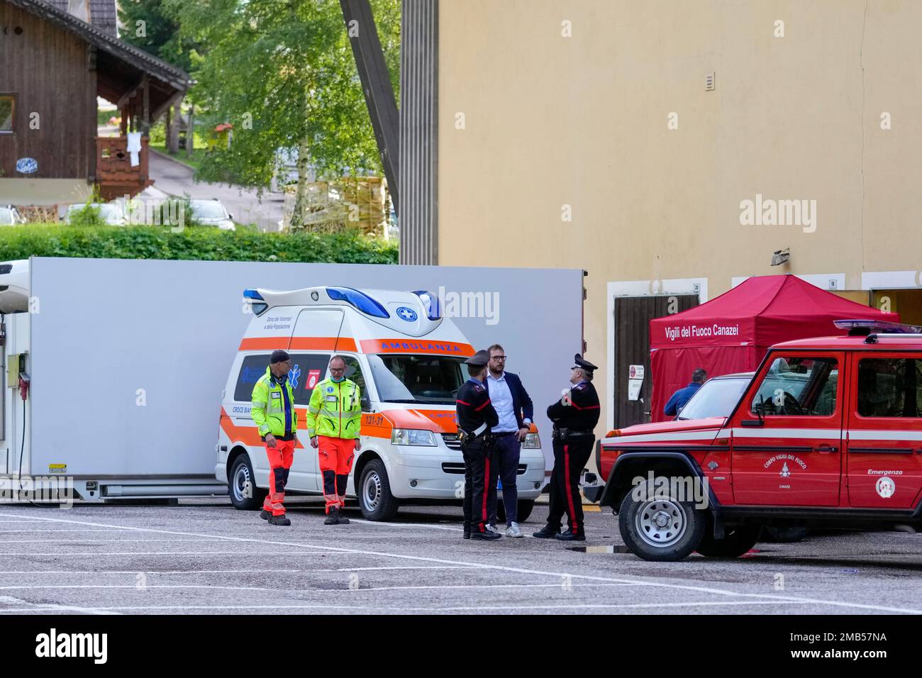 Carabinieri police officers and rescuers stand by the refrigerated ...