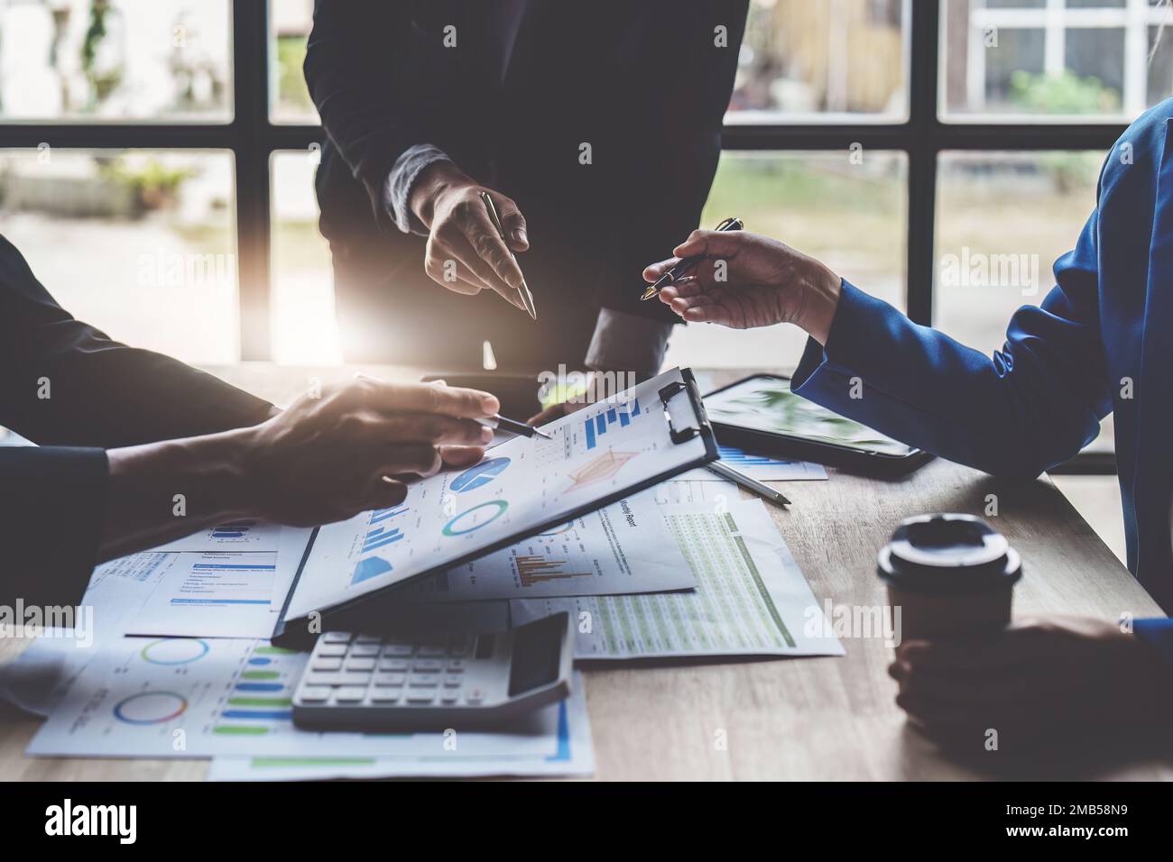 Business financial team with finance reports to analyze big data ...