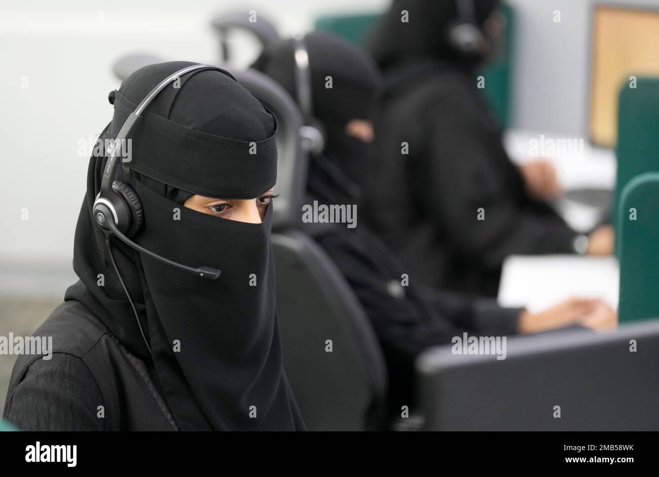Saudi policewomen receive calls at the the Saudi National Center for ...