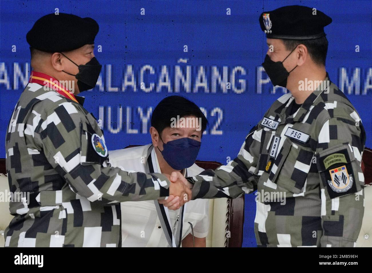 Philippine President Ferdinand Marcos Jr., center, looks as new ...