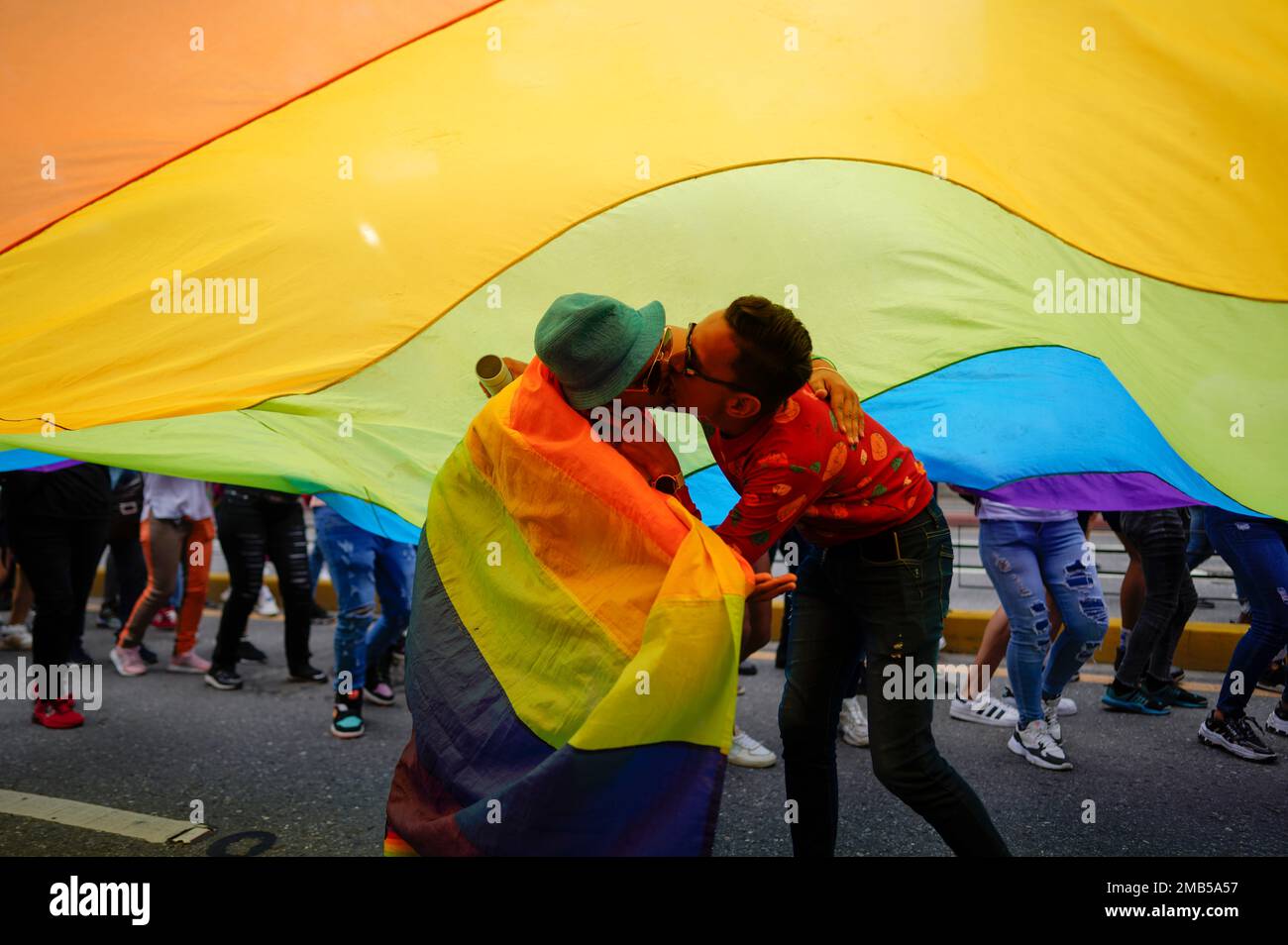 A couple kiss as they participate in the Gay Pride parade in Caracas ...