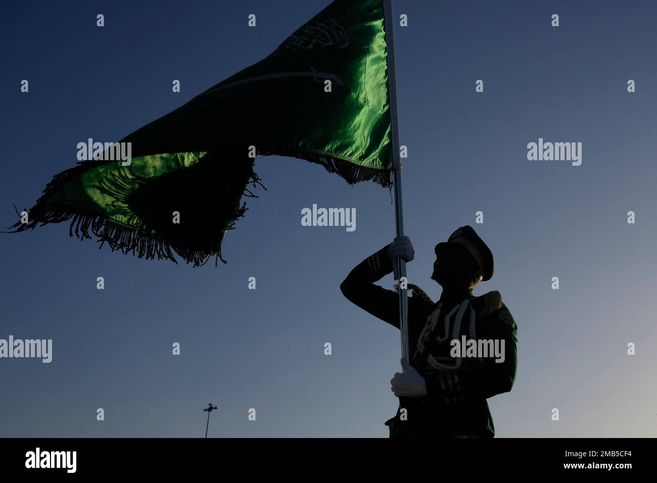 A members of the Saudi special forces holds up the Saudi national flag ...
