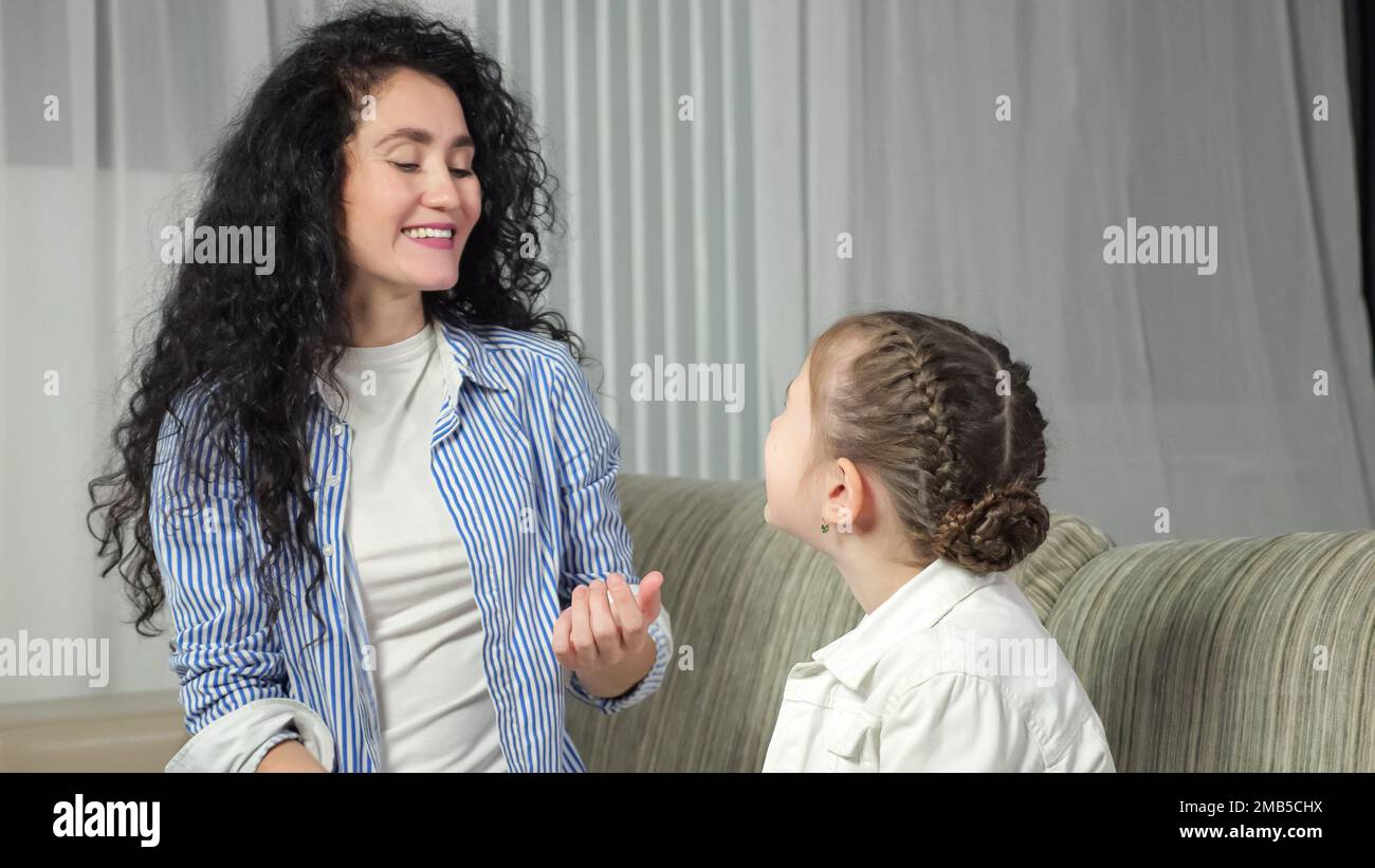 Speech therapist helps girl kid make correct sound at home Stock Photo ...