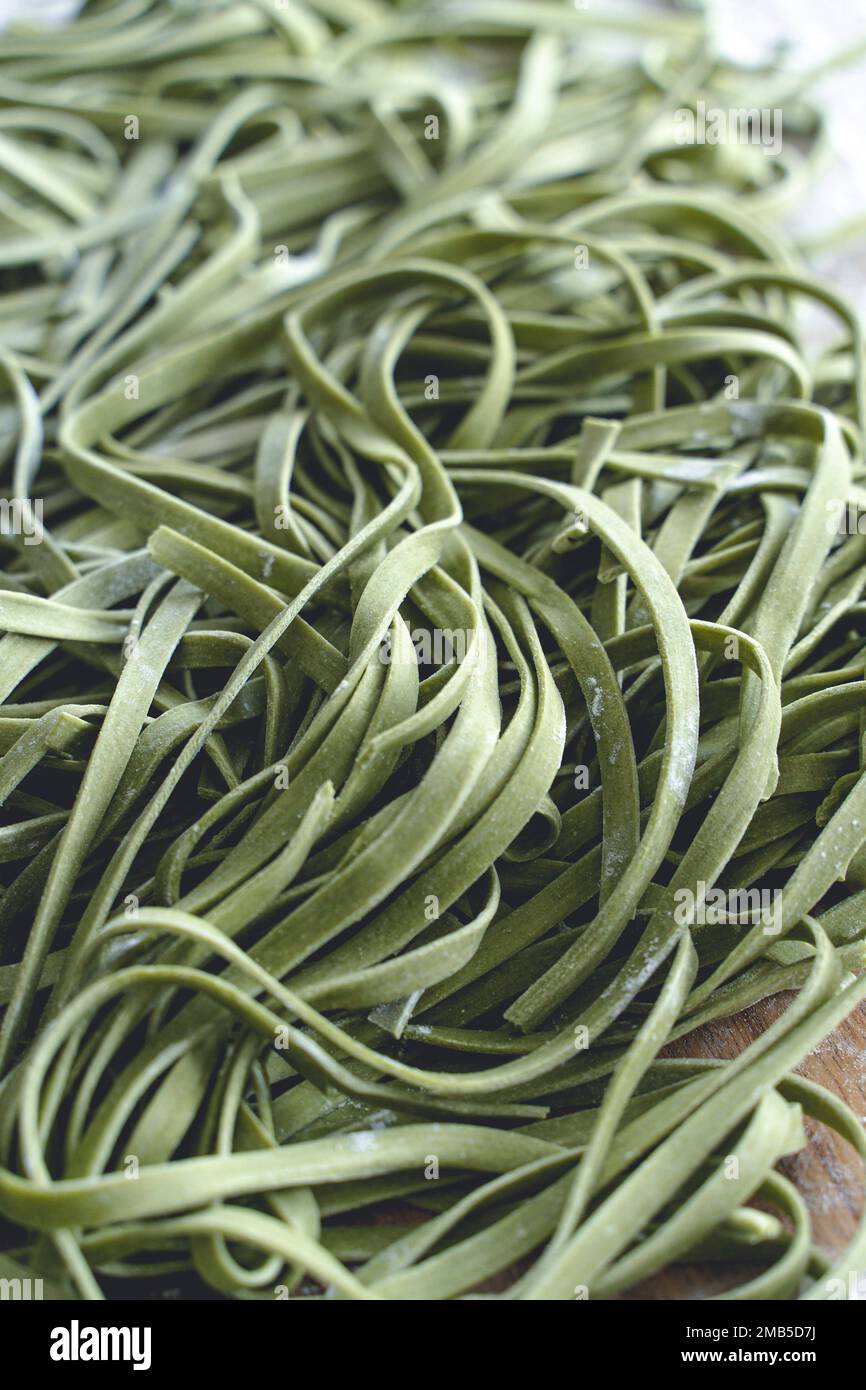 Fresh pasta. Homemade italian raw fettuccine pasta with spinach on ...