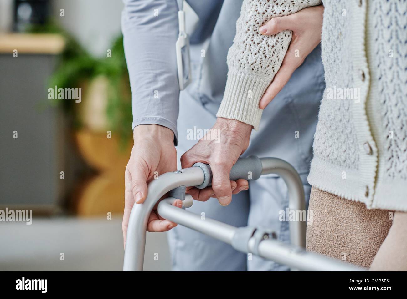 Caregiver helping old woman walker hi-res stock photography and images ...