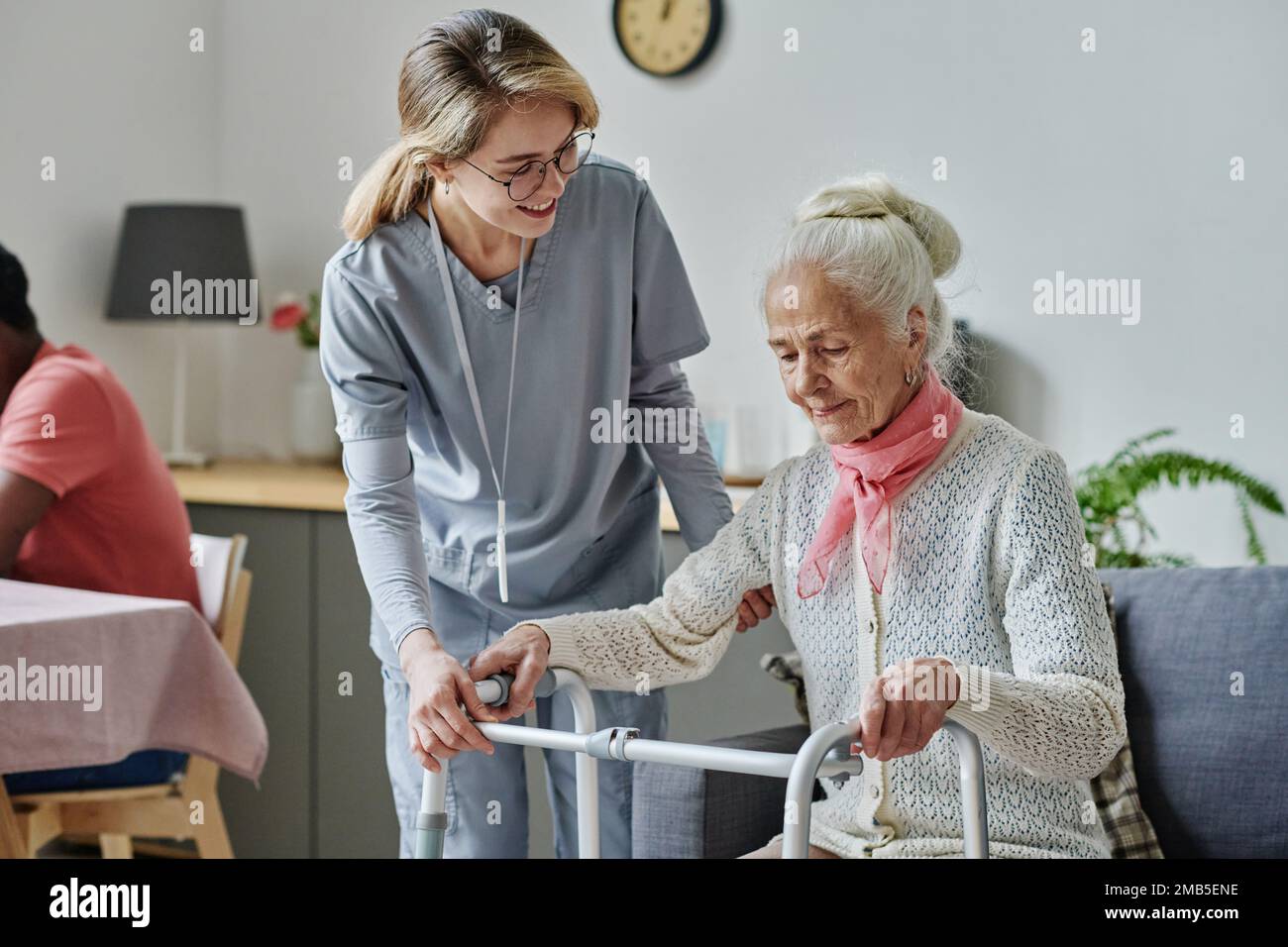 Caregiver helping old woman walker hi-res stock photography and images ...
