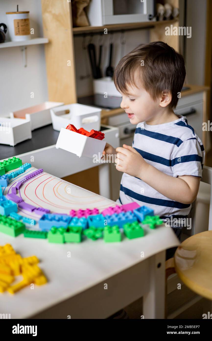 Khabarovsk, Russia, May 11, 2022. Smiling baby boy playing Lego ...