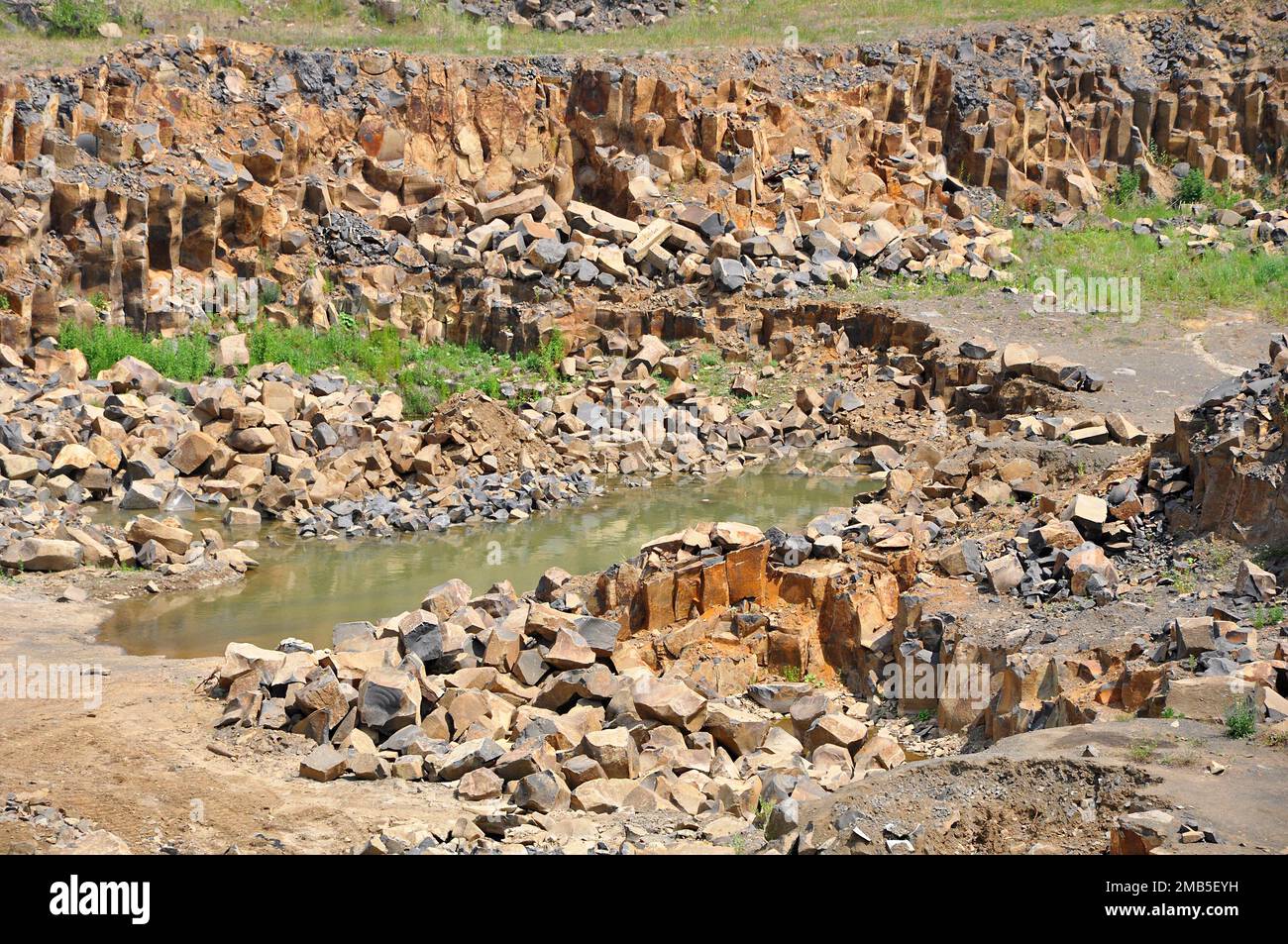 Many stones in the columnar basalt quarry in sunny day Stock Photo - Alamy