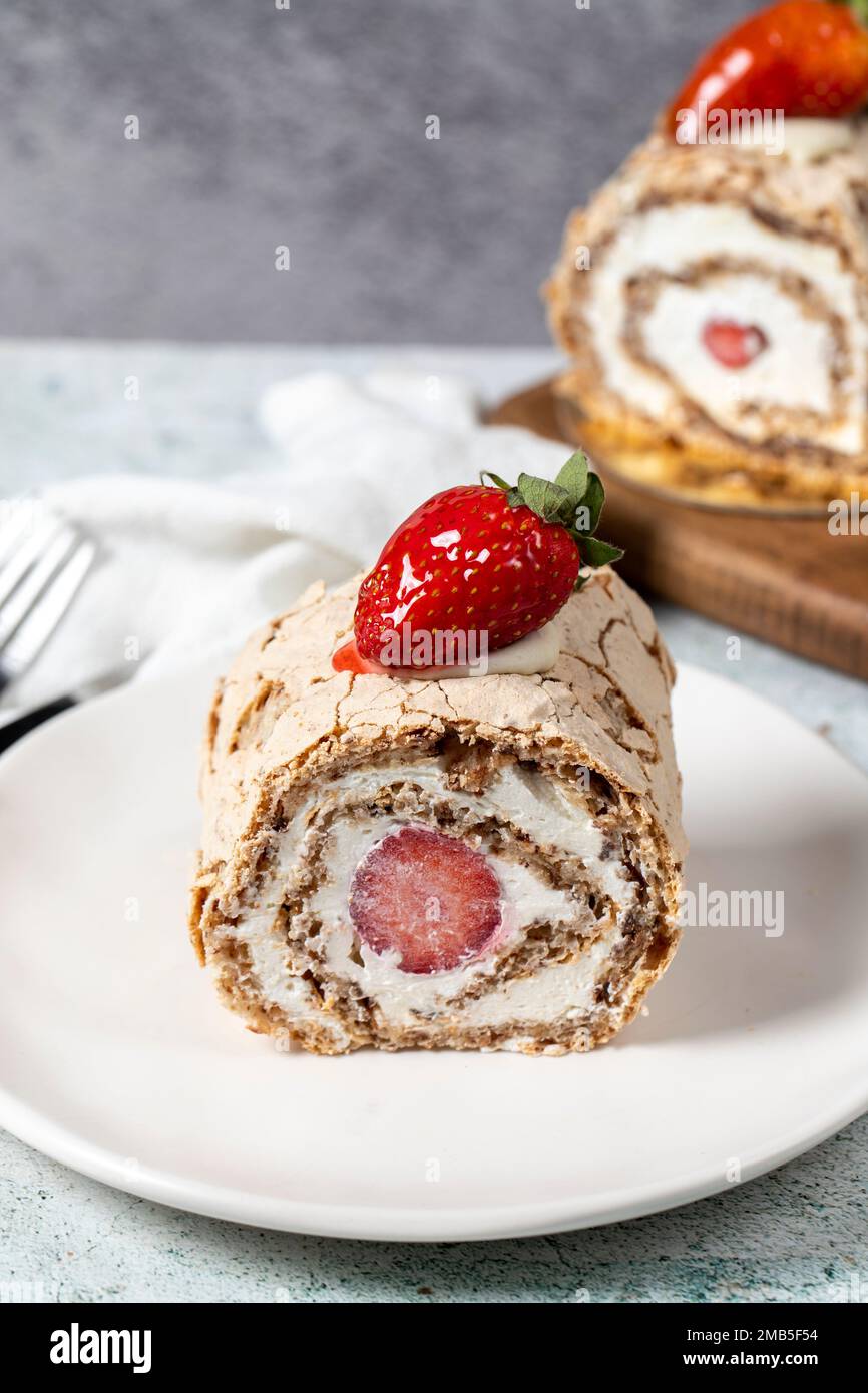 Strawberry Roll Cake. Log cake with cream and strawberries on a stone ...