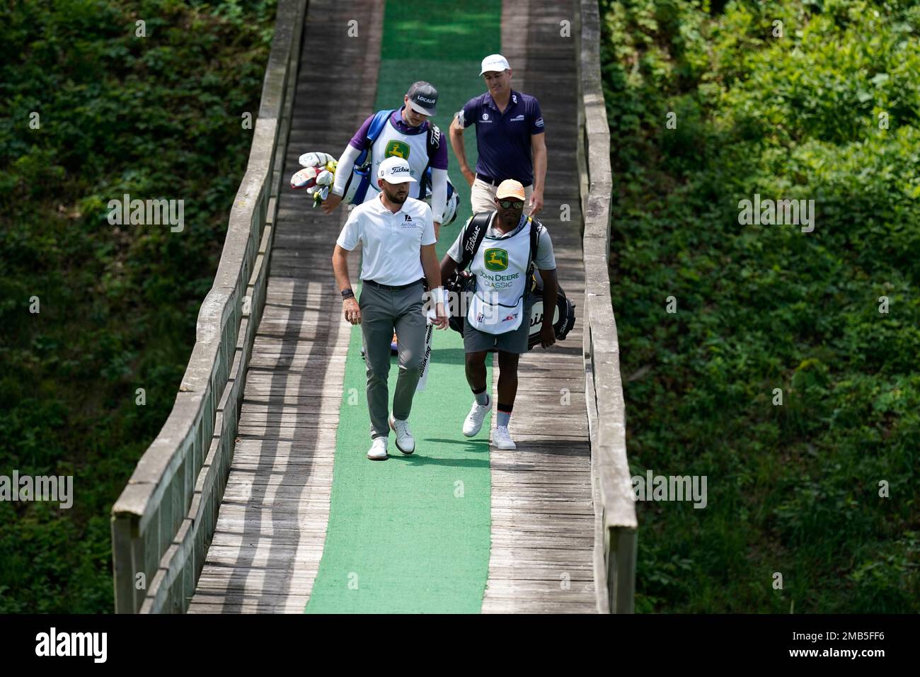 Hayden Buckley, left, walks with his caddie across a bridge on the ...
