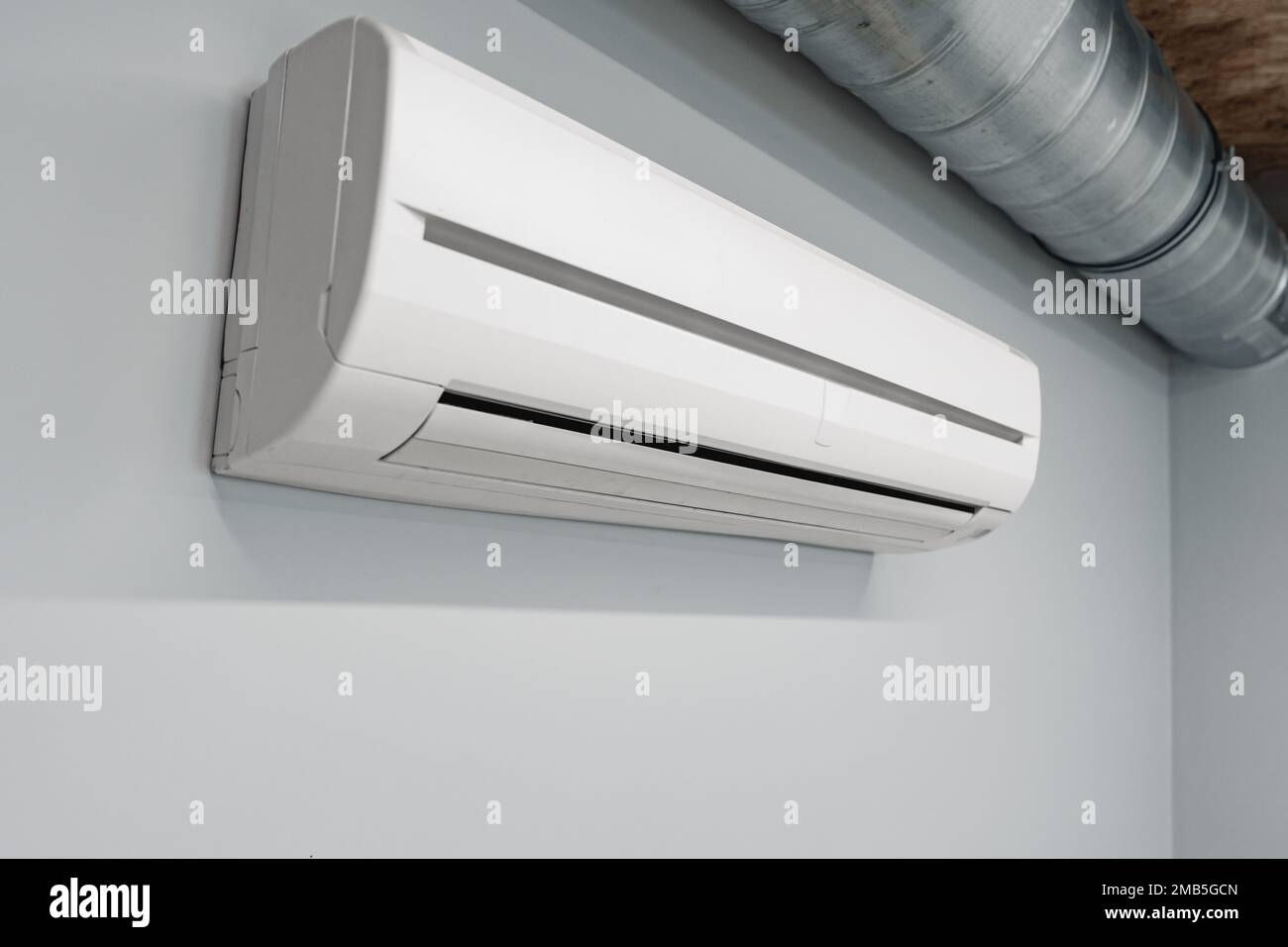 Air conditioner on gray wall room interior Stock Photo - Alamy