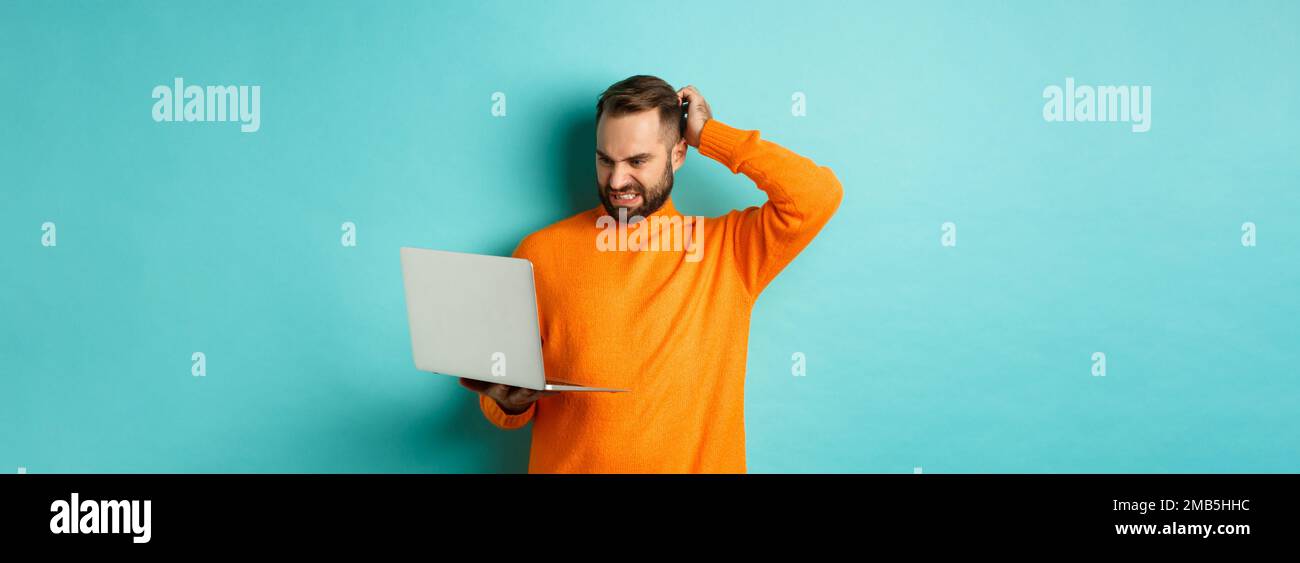 Freelance and technology concept. Confused man scratching head and ...