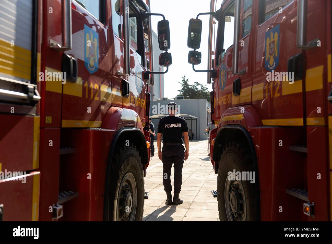 A Romanian firefighter stands in front of a fire engine during a ...
