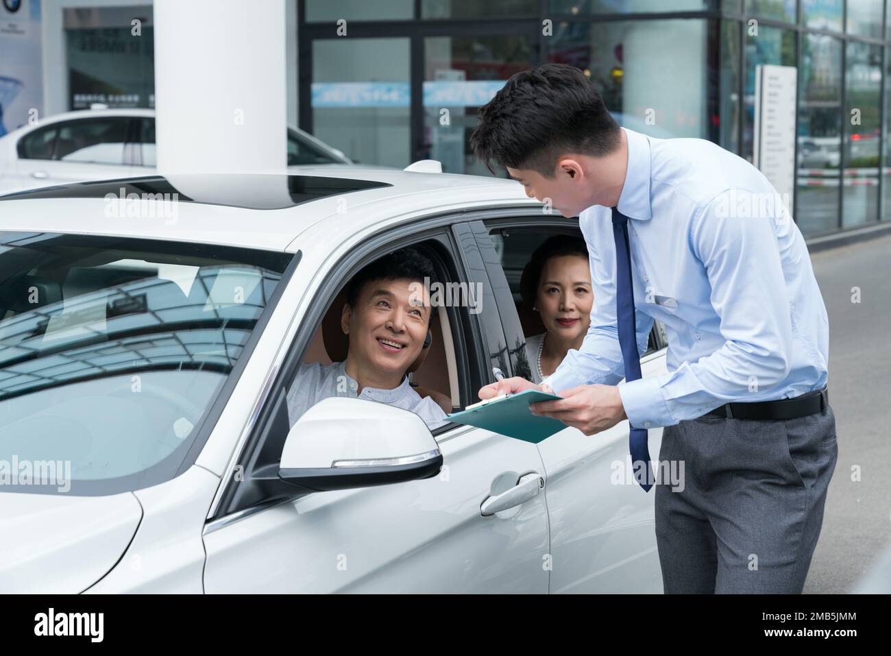 Elderly couples test drive cars Stock Photo - Alamy
